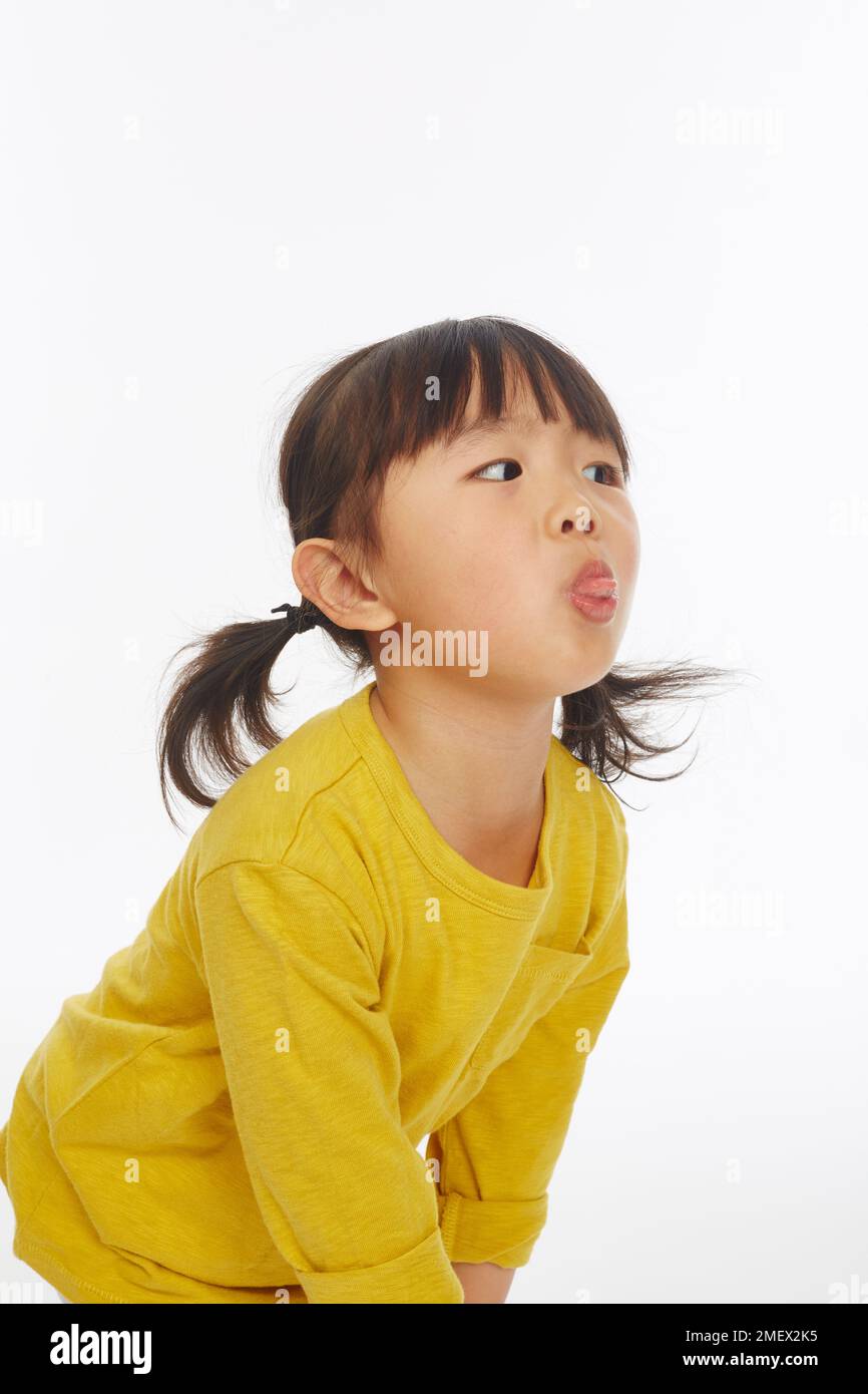 Little girl in yellow, making faces (Model age 2 years Stock Photo - Alamy