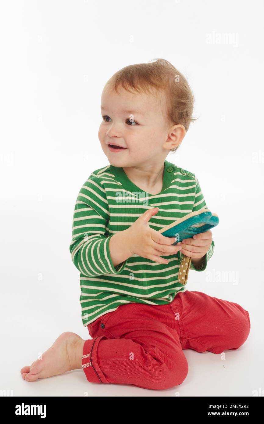 Little boy in green stripey top playing, various poses (Model age - 22 ...