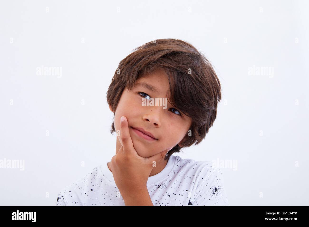 Boy think looking up, hold hand on chin Stock Photo - Alamy