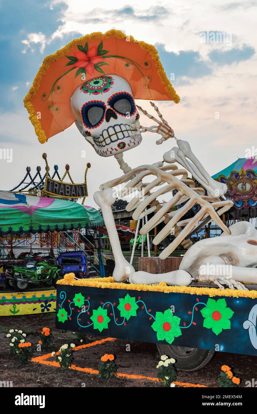 A large skeleton parade float with a flower crown for the Day of the ...