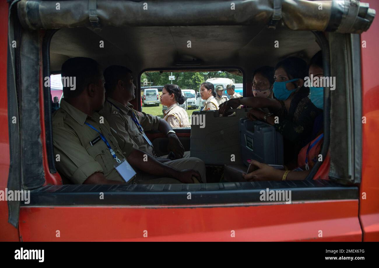 Election officials carry Electronic Voting Machines (EVM) on a vehicle ...