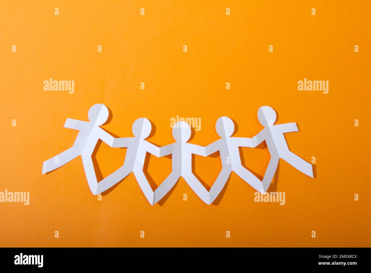 White paperchain on an orange background Stock Photo - Alamy