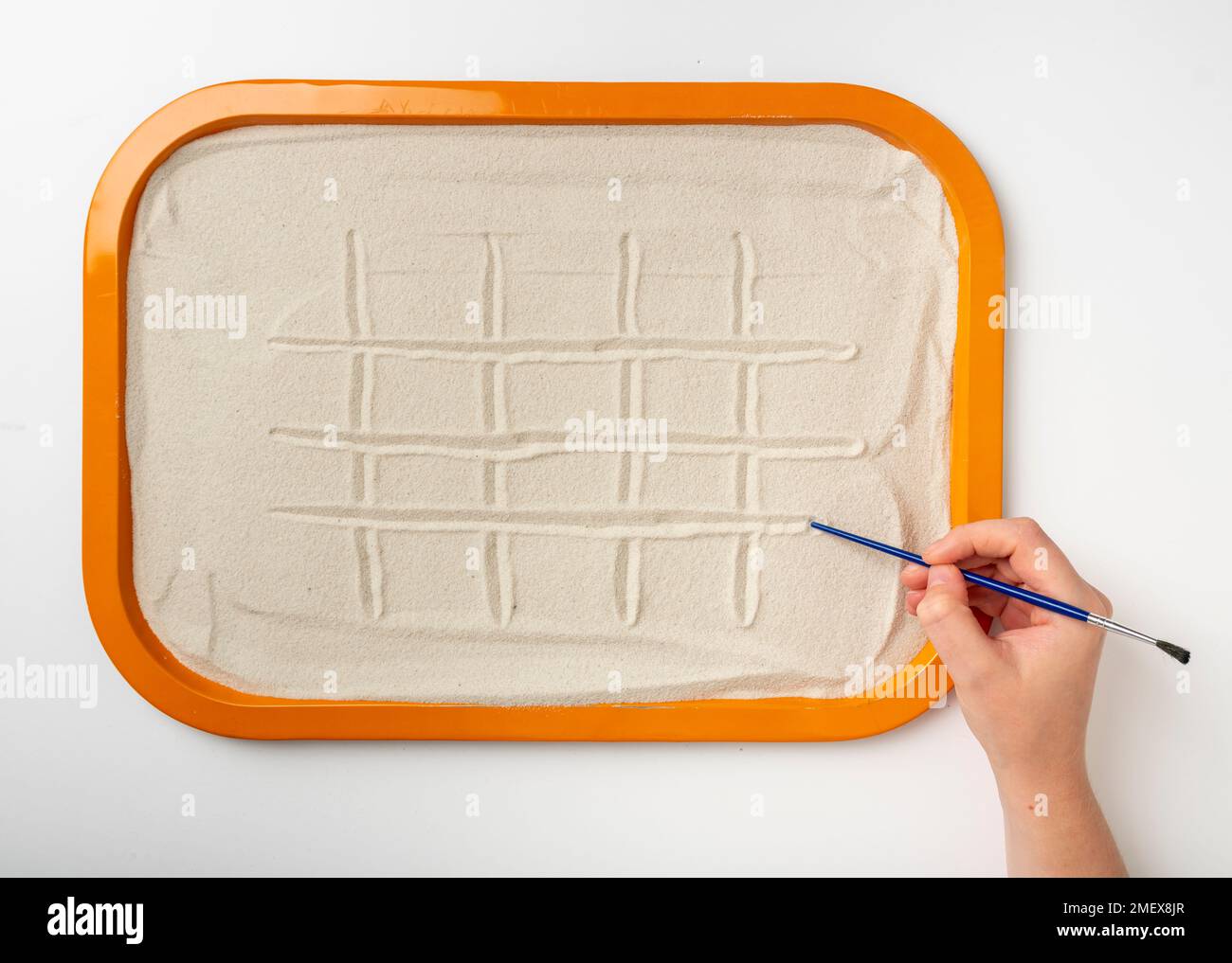 Hand drawing horizontal lines in sand Stock Photo - Alamy