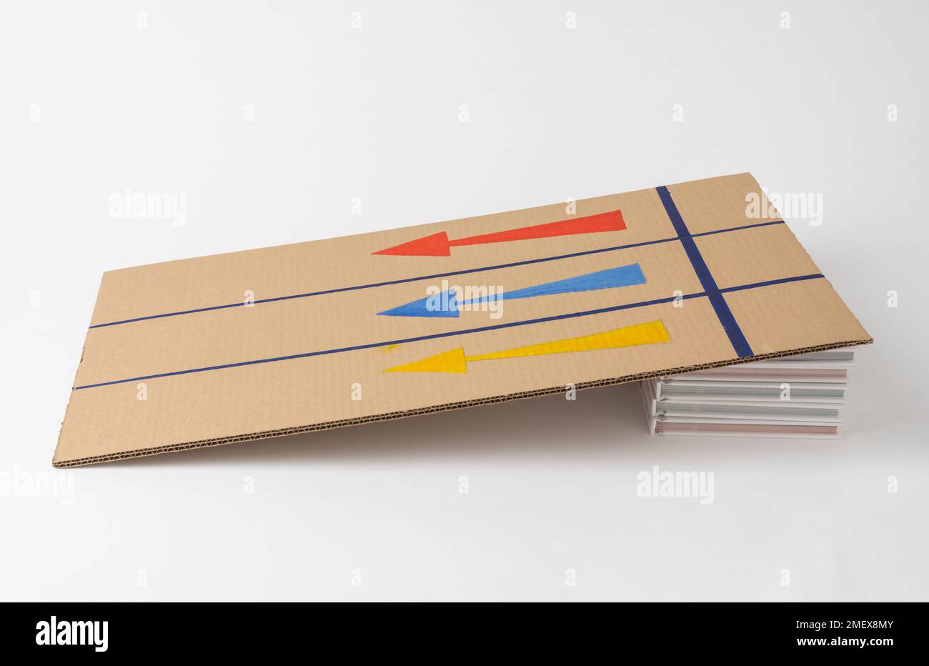 Carboard racetrack ramp on books Stock Photo - Alamy