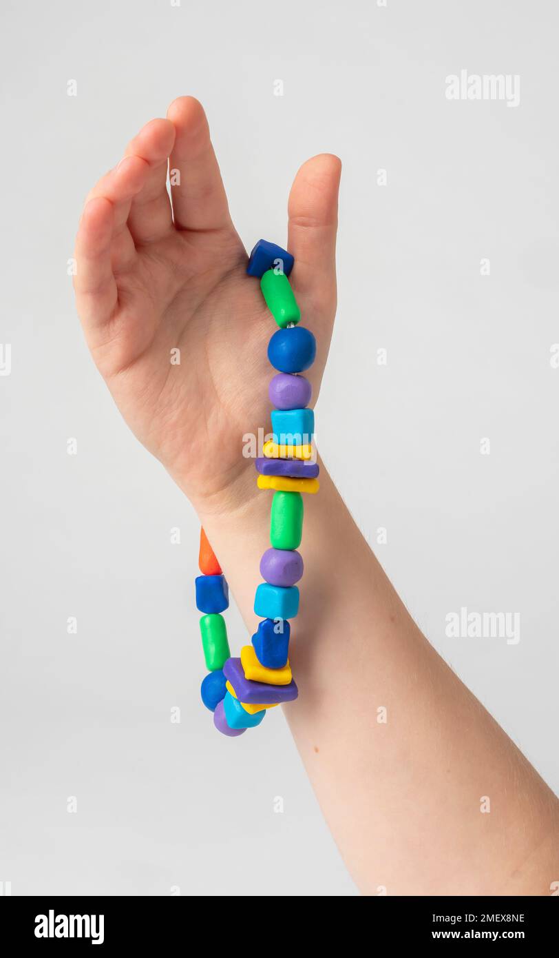 Hand holding beaded necklace Stock Photo - Alamy