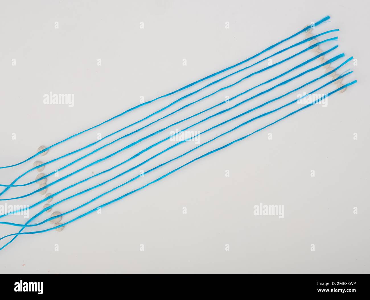 String in lines hled by white tac Stock Photo - Alamy