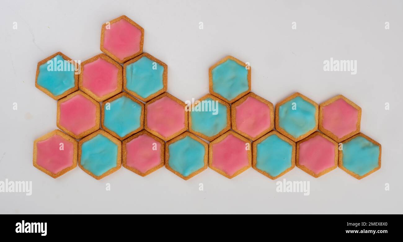 Hexagon biscuits with pink and blue icing Stock Photo - Alamy