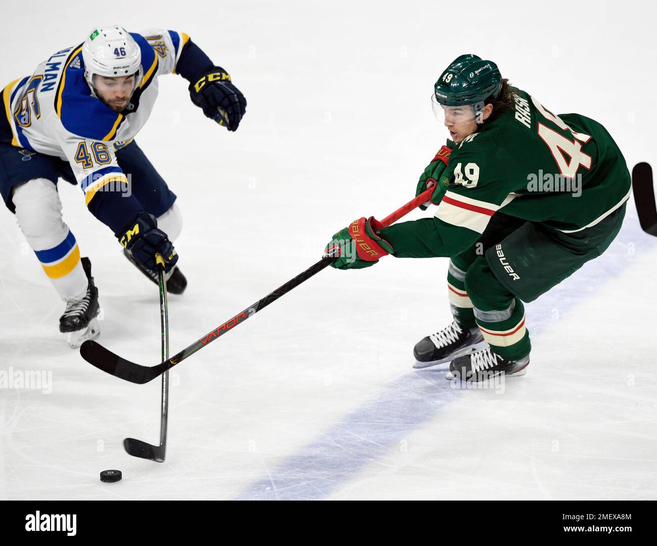 St. Louis Blues' Jake Walman (46) gets the puck away from Minnesota ...