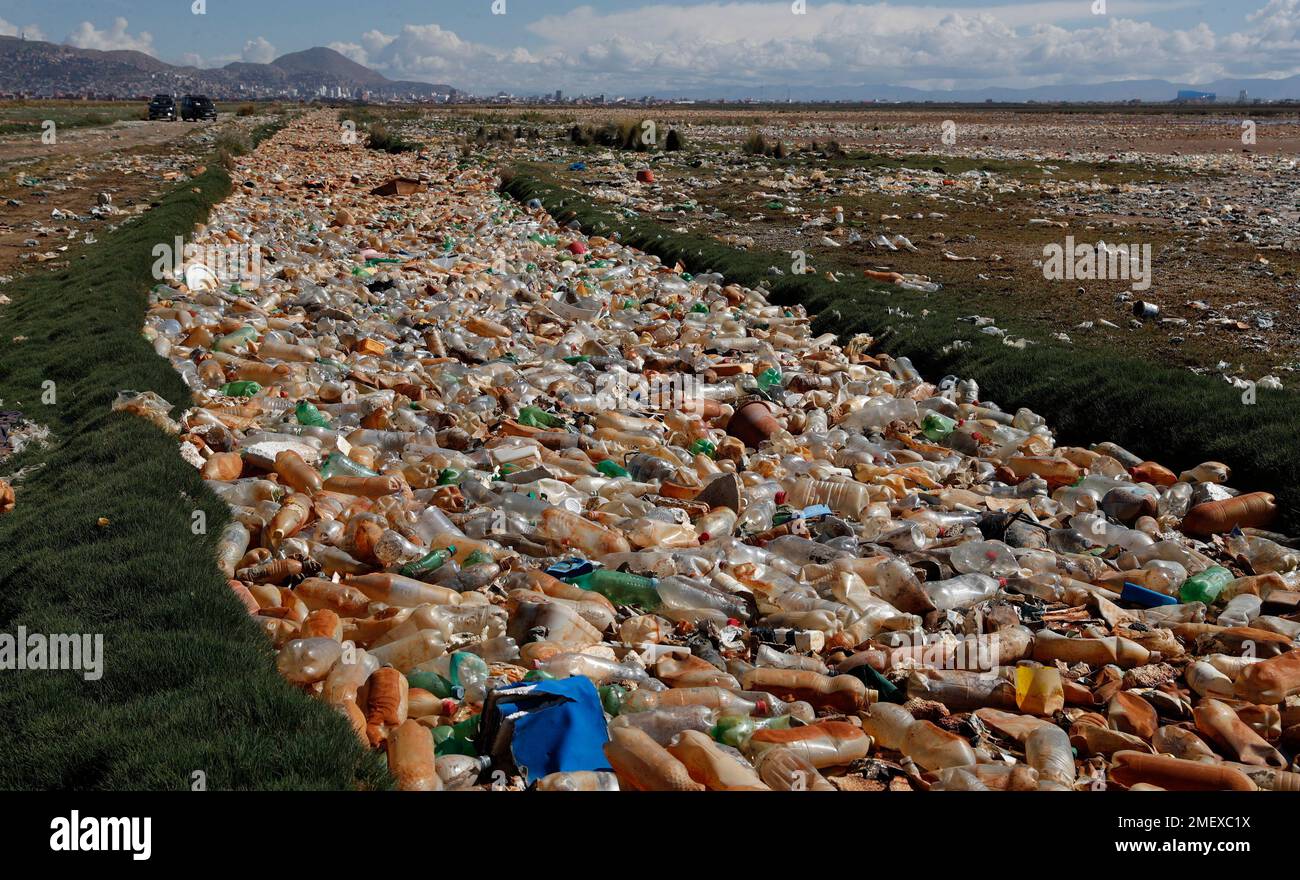 Plastic bottles and garbage float on the Tagaret River, which flows ...