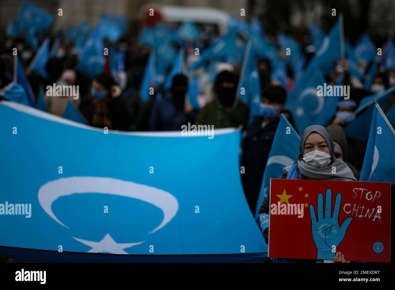 A protester from the Uyghur community living in Turkey, holds an anti ...