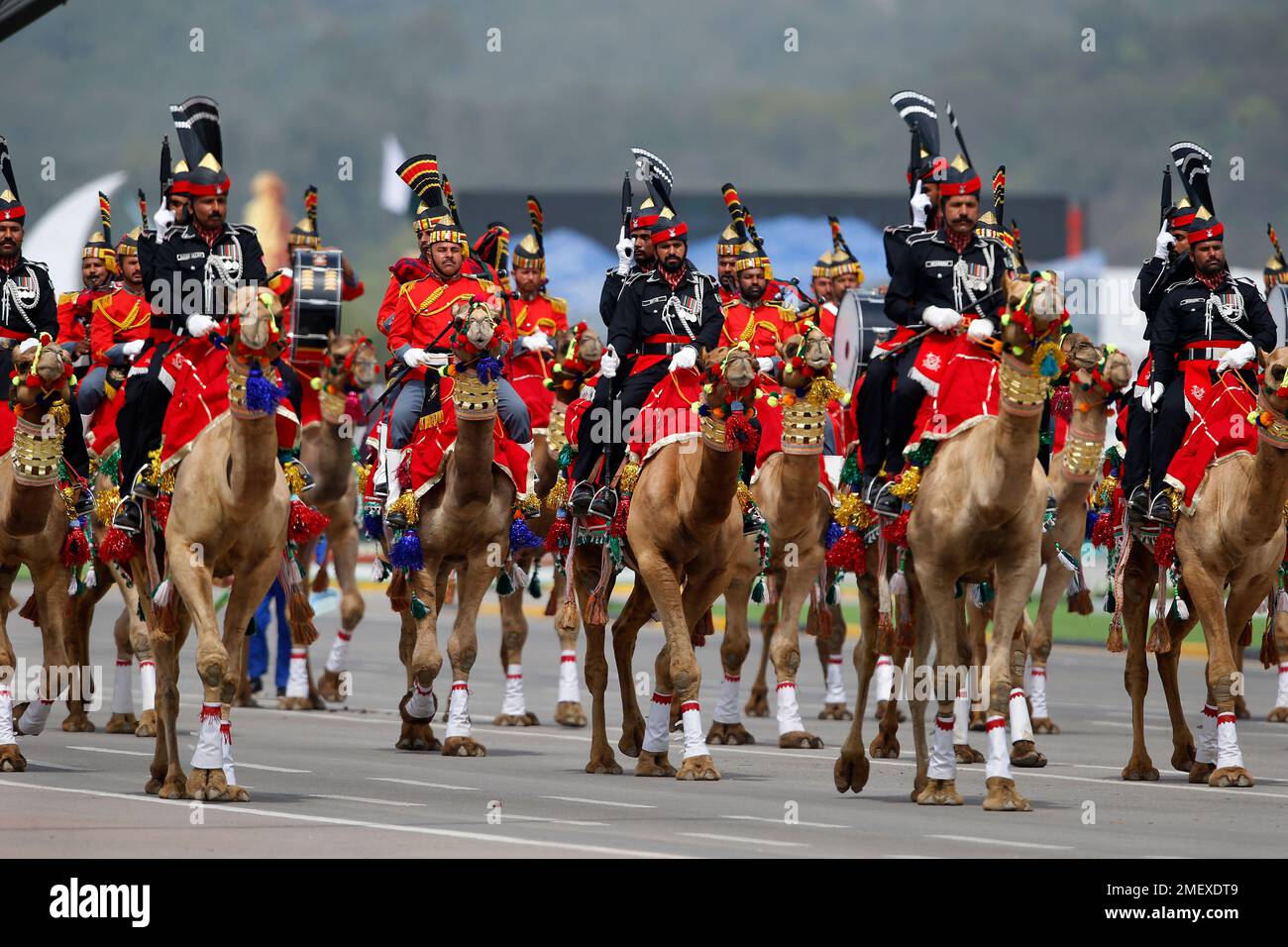 A Pakistani army musical band parades on camelback during a military ...