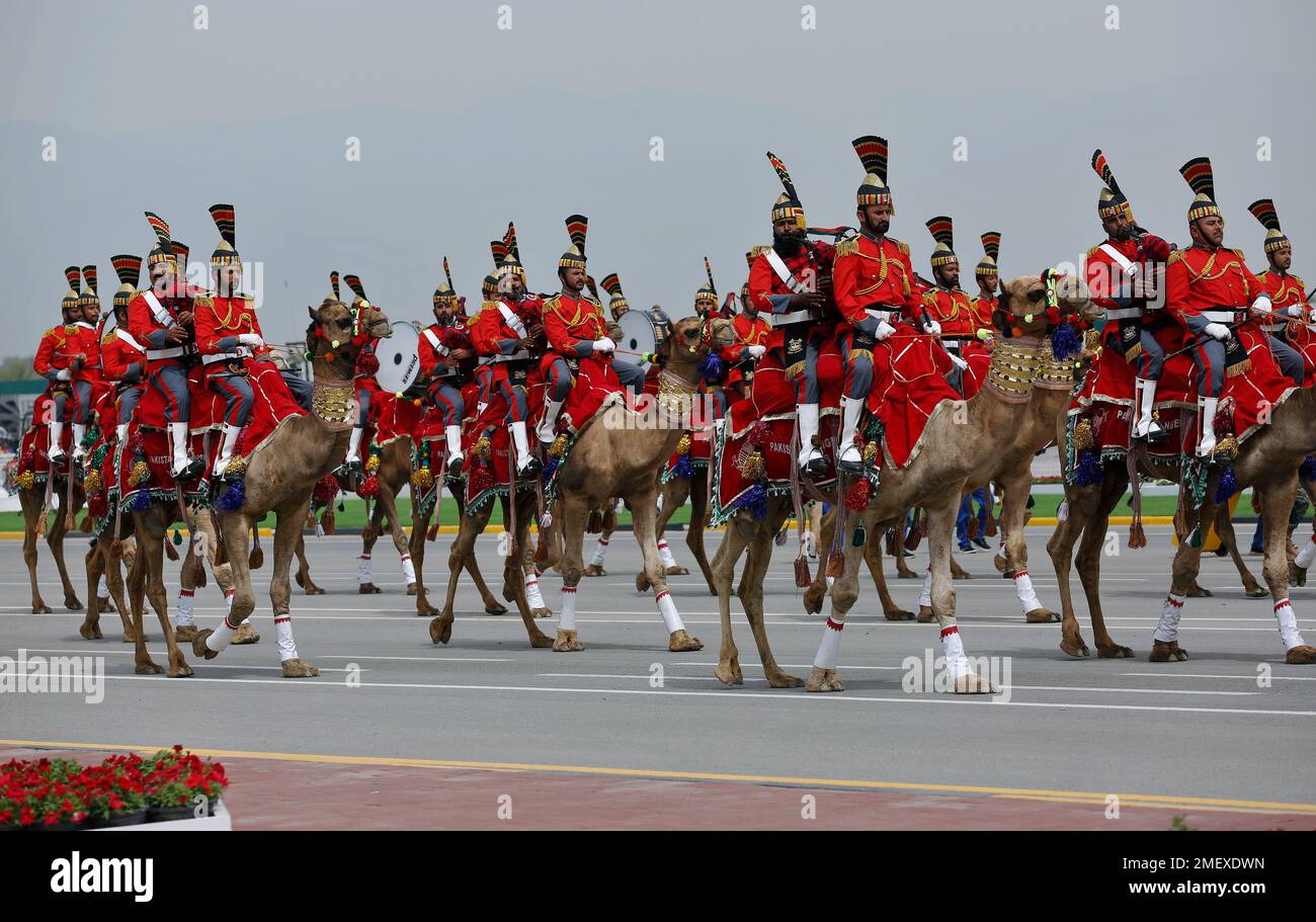 A Pakistan army musical band parades on camelback during a military ...