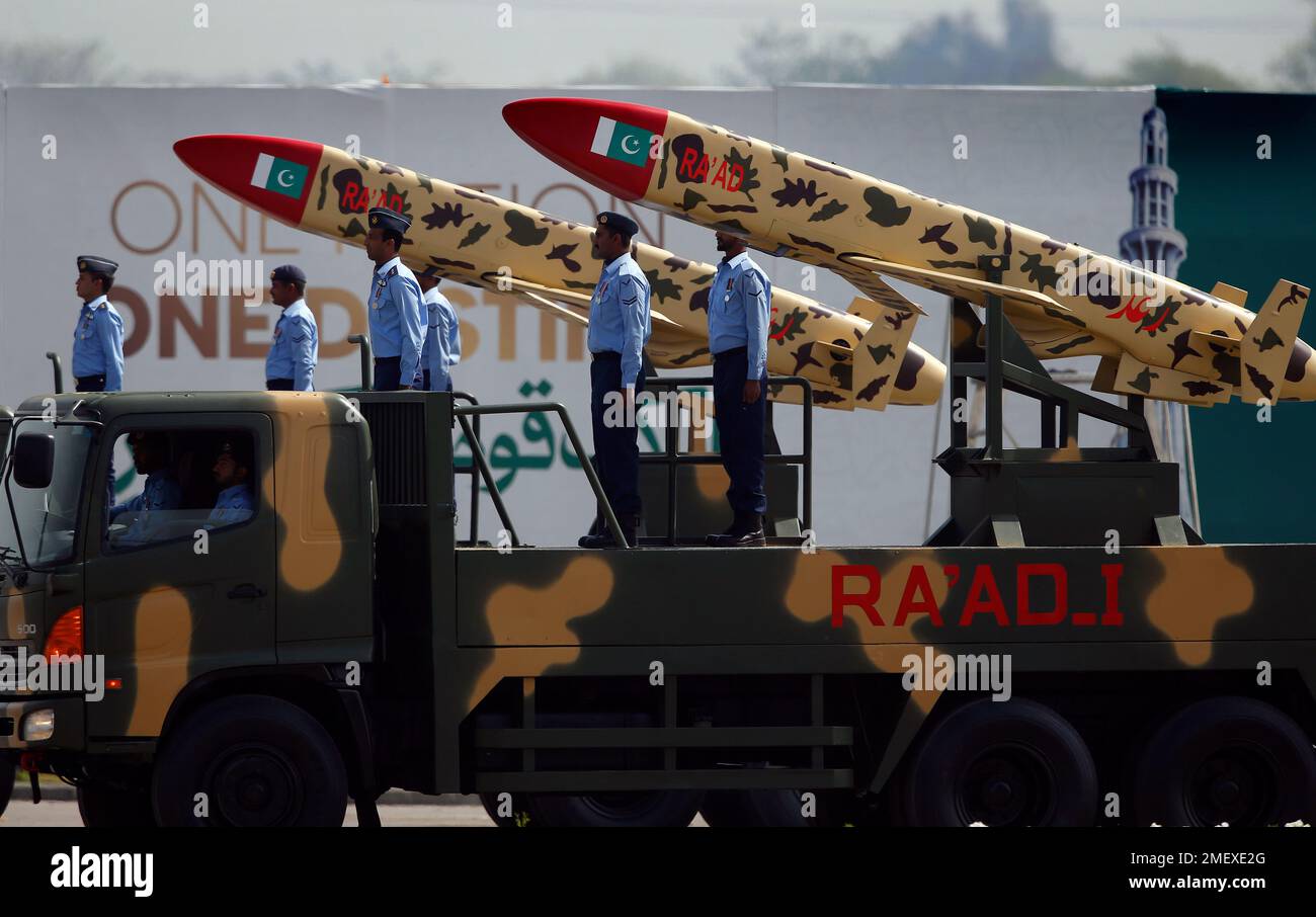 Soldiers stand beside Pakistani-made Ra'ad Cruise missiles are loaded ...