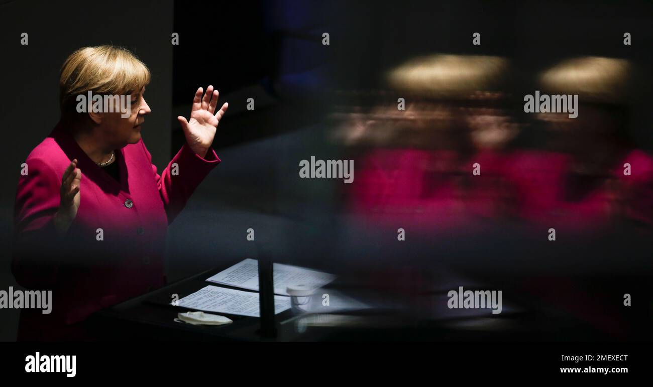 German Chancellor Angela Merkel addresses the German parliament ...