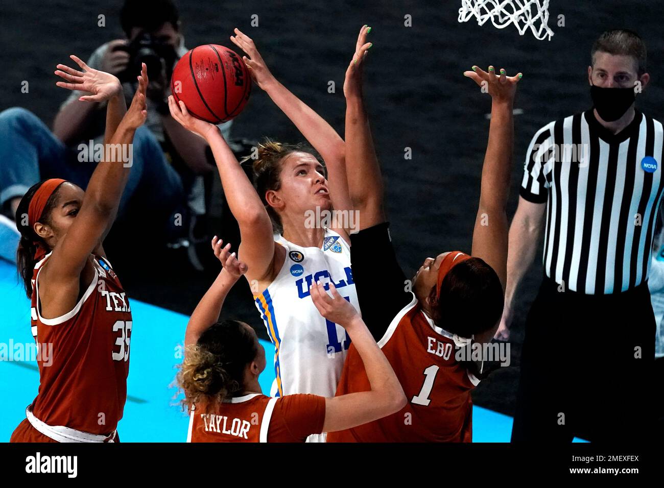 UCLA forward Emily Bessoir (11) shoots under pressure from Texas ...
