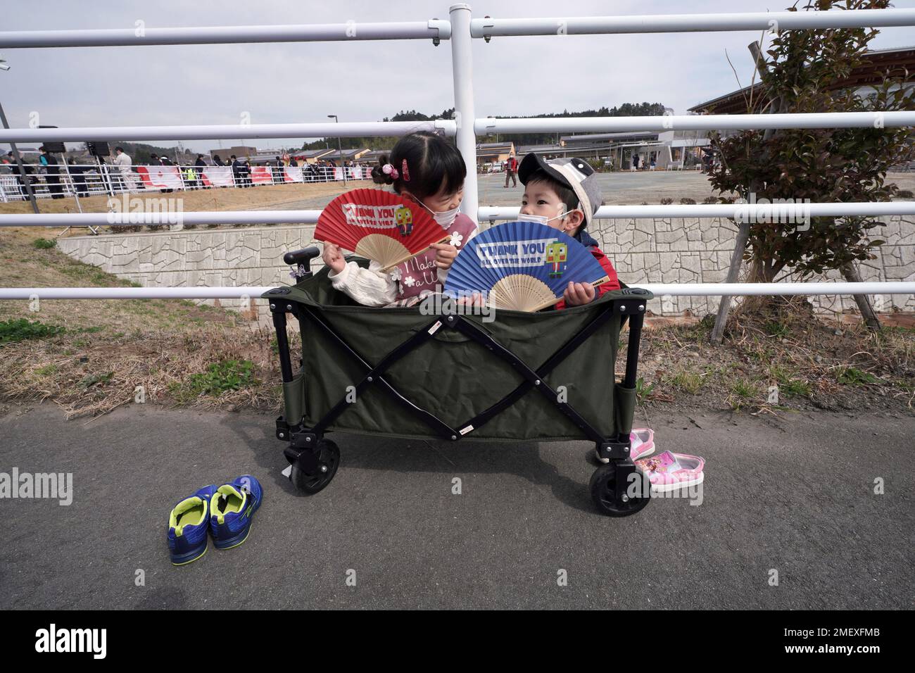 Local children wait for torchbearers to arrive at the torch relay route ...