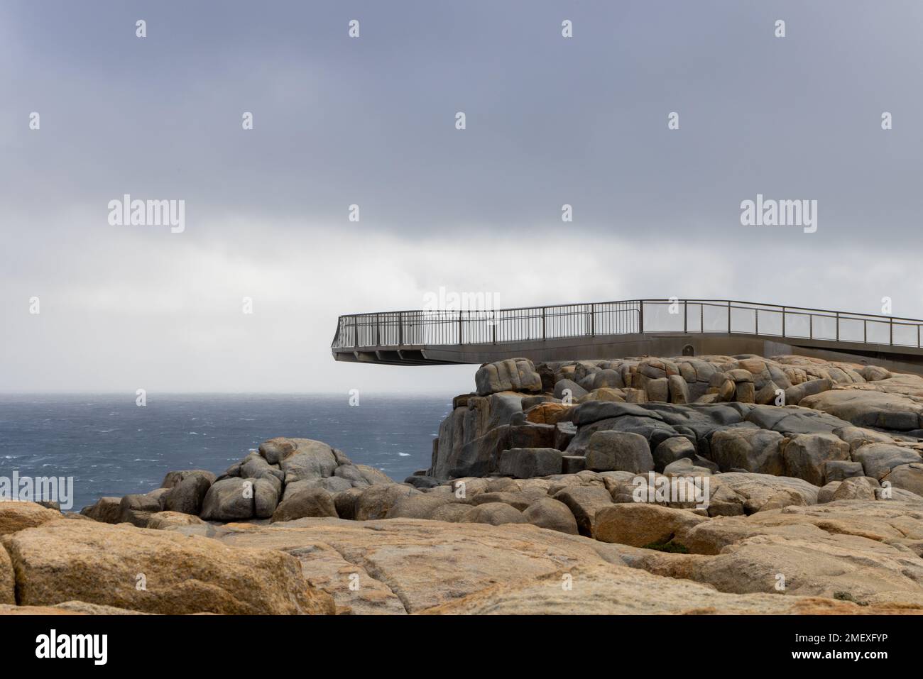 weathered rocks supporting metal walkway and cantilevered viewing ...