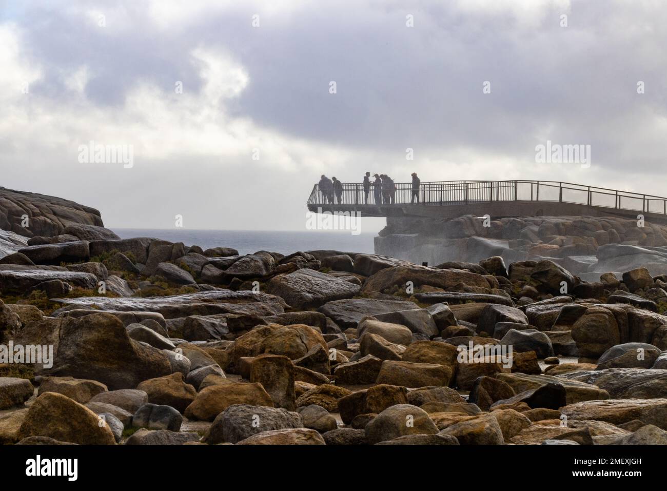 group of people brave cold windy weather to view the gap from a ...