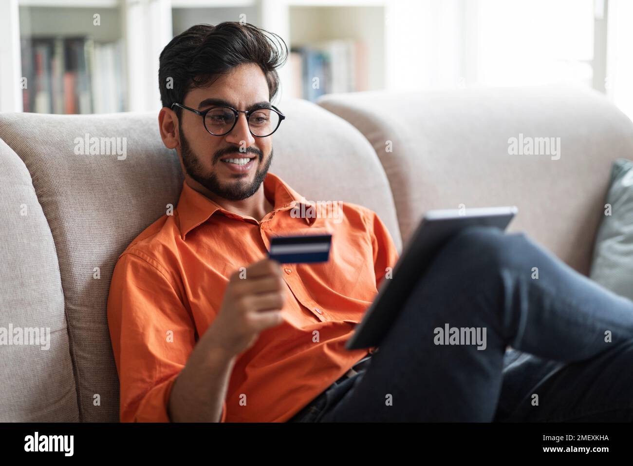 Positive arabic guy enjoying newest banking mobile app on pad Stock ...