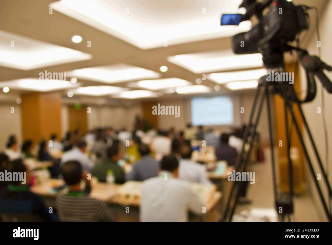 A blurred image of people sitting in a conference room Stock Photo - Alamy