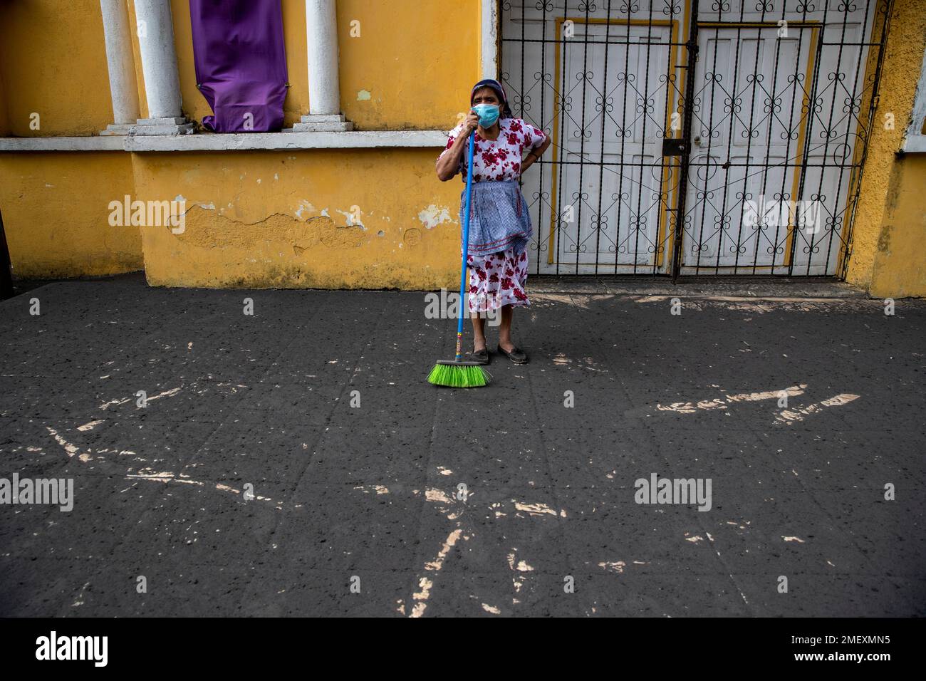 Lidia Esperanza Guzman takes a break from sweeping volcanic ash from ...