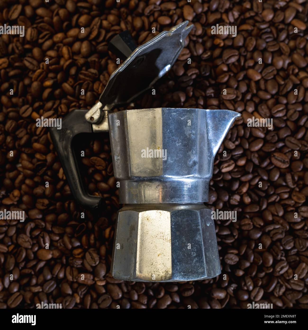 Italian geyser coffee maker on a background of coffee beans Stock Photo ...