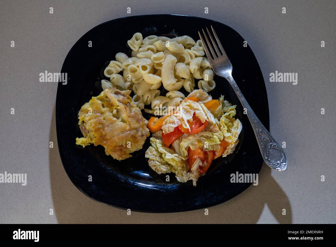 Pasta, salad and cucumber on a plate Stock Photo - Alamy