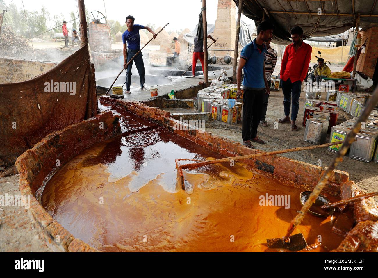 People work at a jaggery factory on the outskirts of Bareilly, India ...