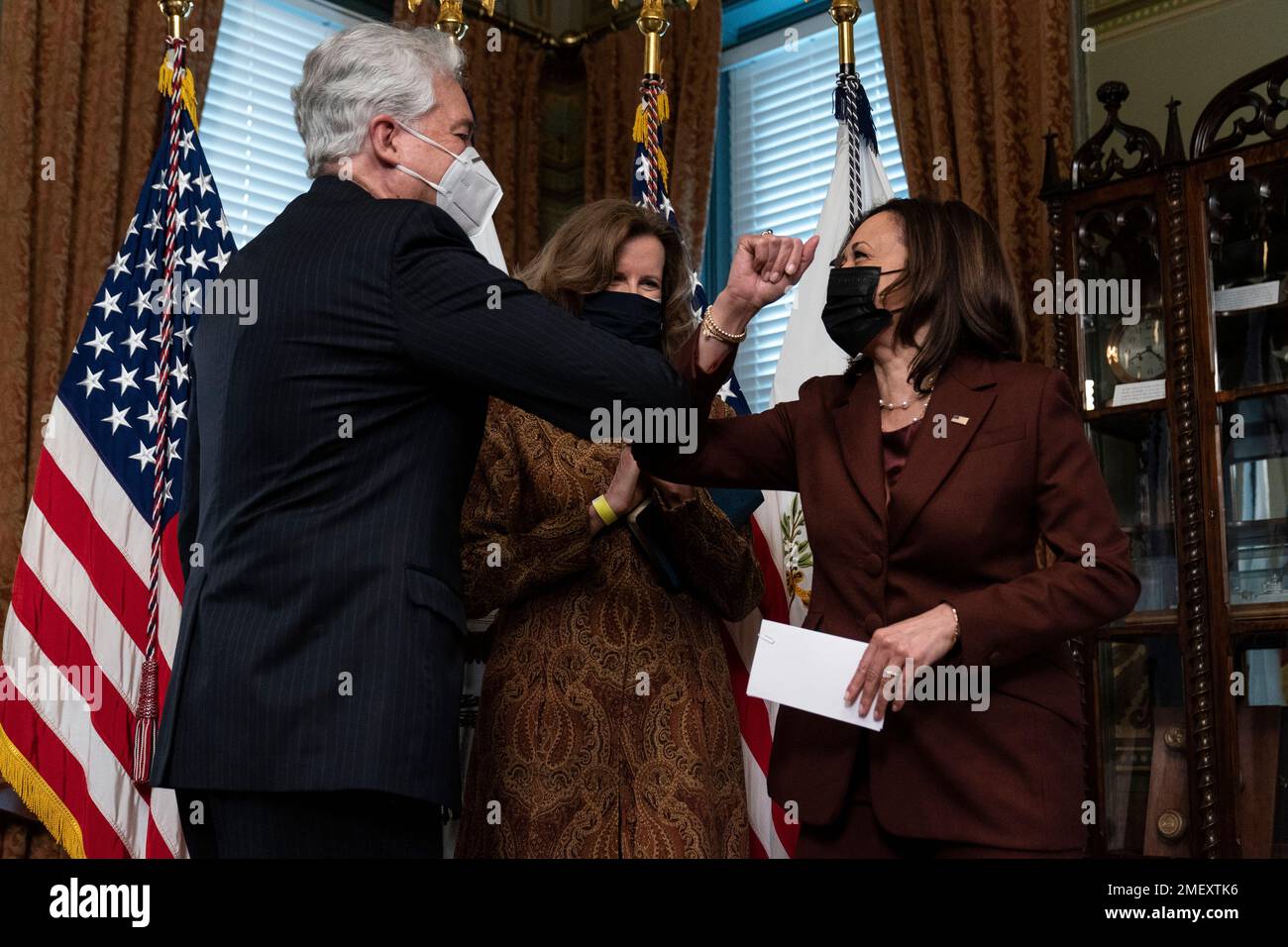 Vice President Kamala Harris, right, elbow bumps CIA director William ...