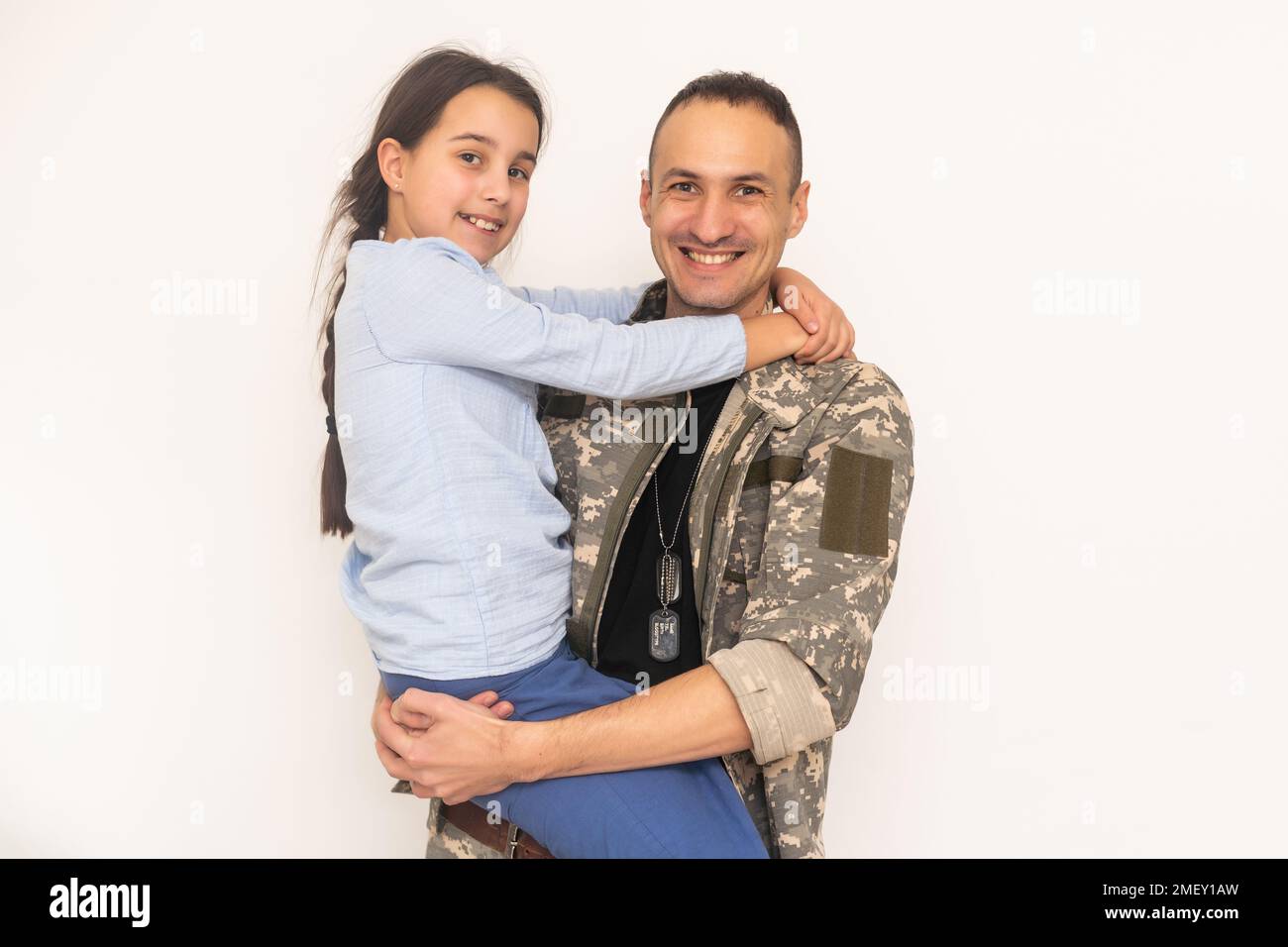Affectionate girl looking at camera out of her father back in ...