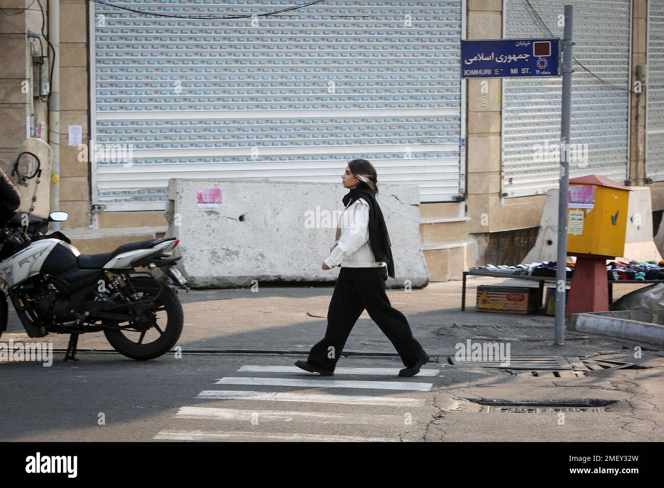 An Iranian woman walks in the street in Tehran as the Iranian capital ...