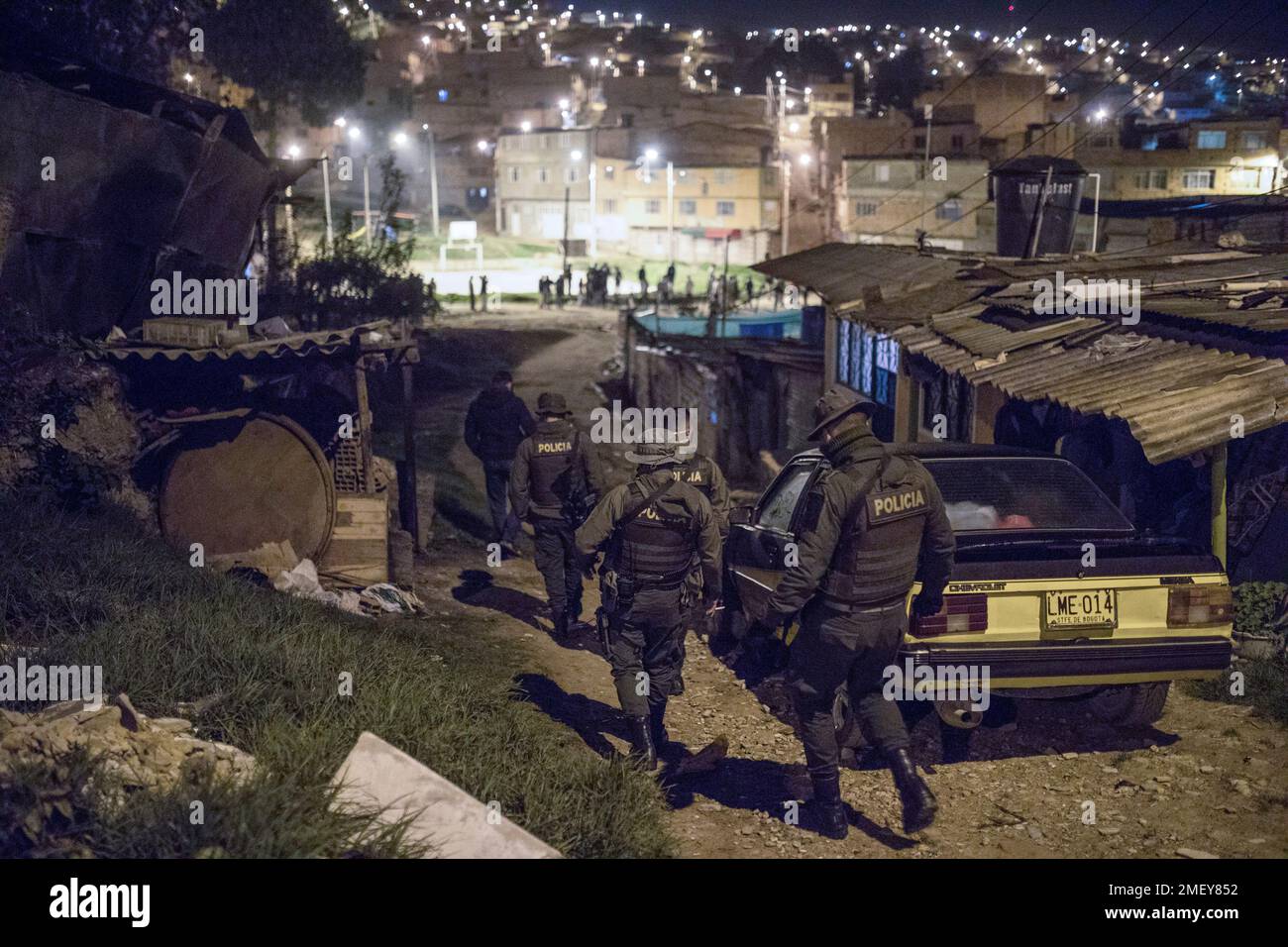 Police officers patrol in Soacha, outskirts of Bogota, late Saturday ...