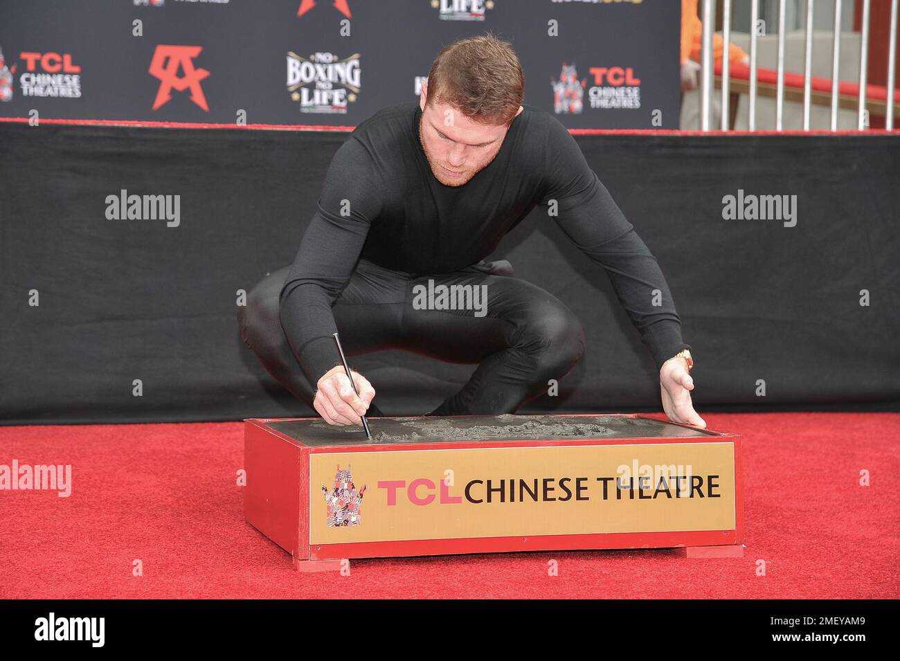 Boxer Canelo Alvarez places his hands and feet in cement during a ...