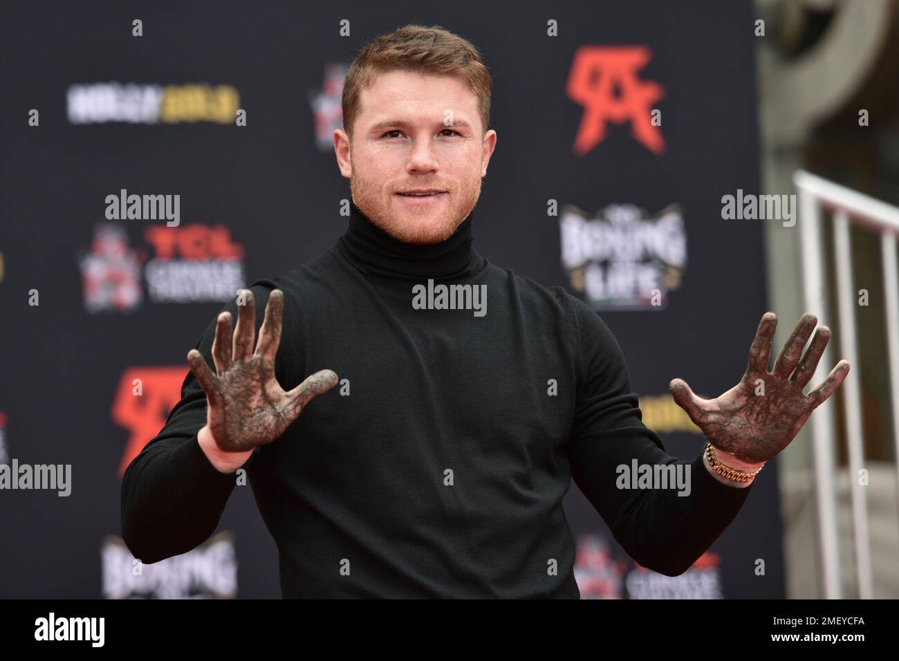 Boxer Canelo Alvarez poses for photos after placing his hands in cement ...