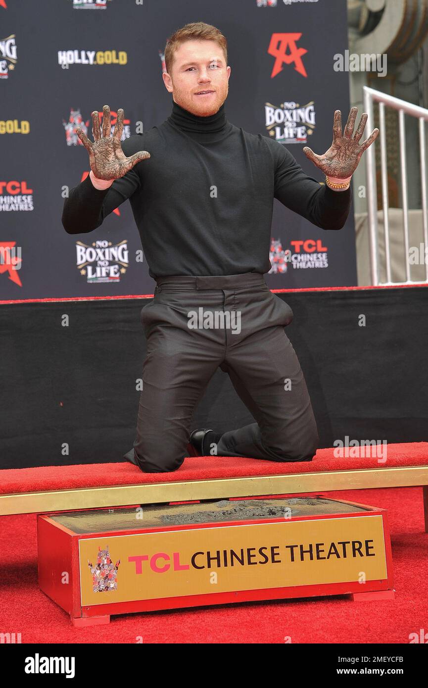 Boxer Canelo Alvarez poses for photos after placing his hands in cement ...