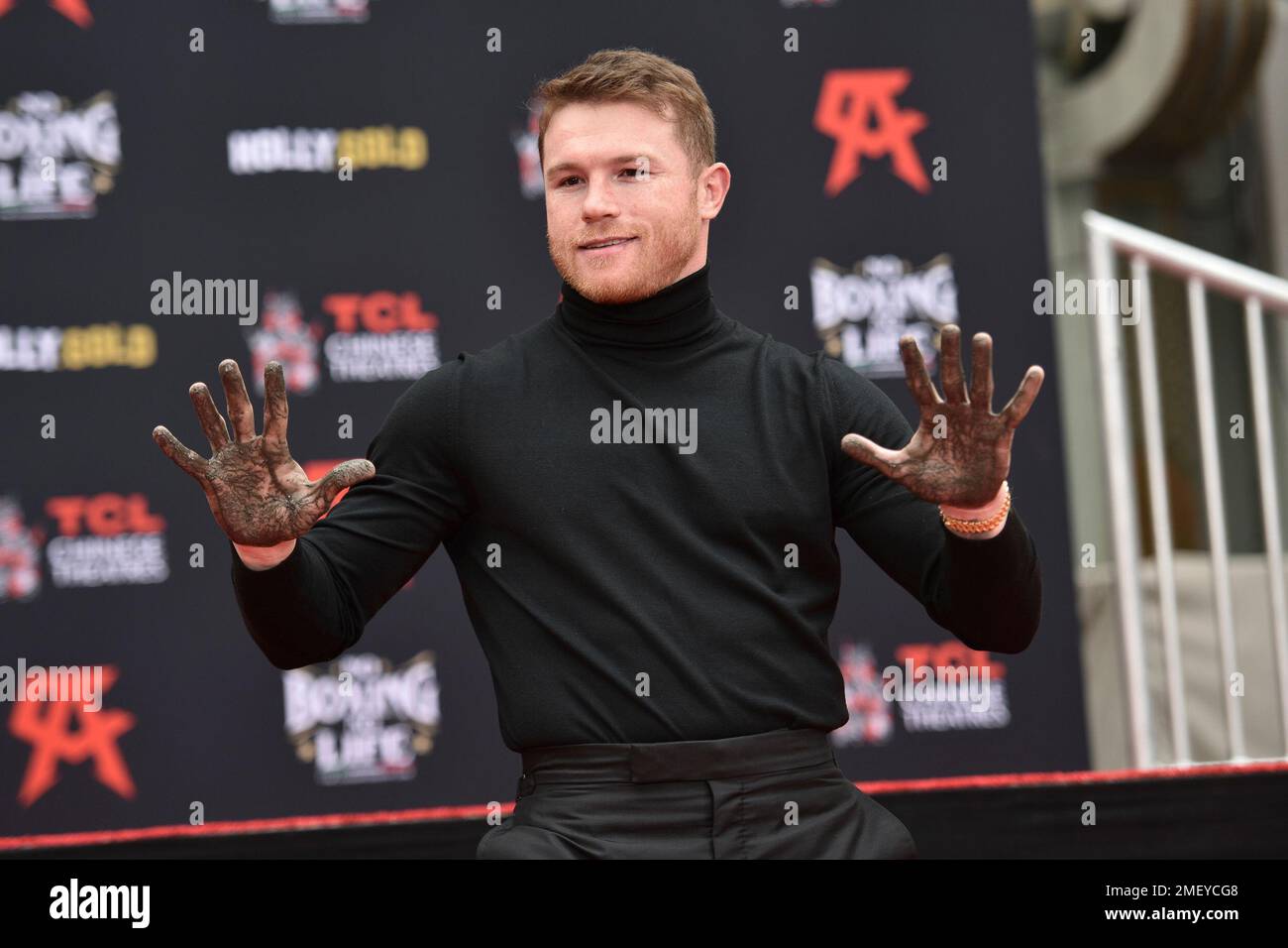 Boxer Canelo Alvarez poses for photos after placing his hands in cement ...