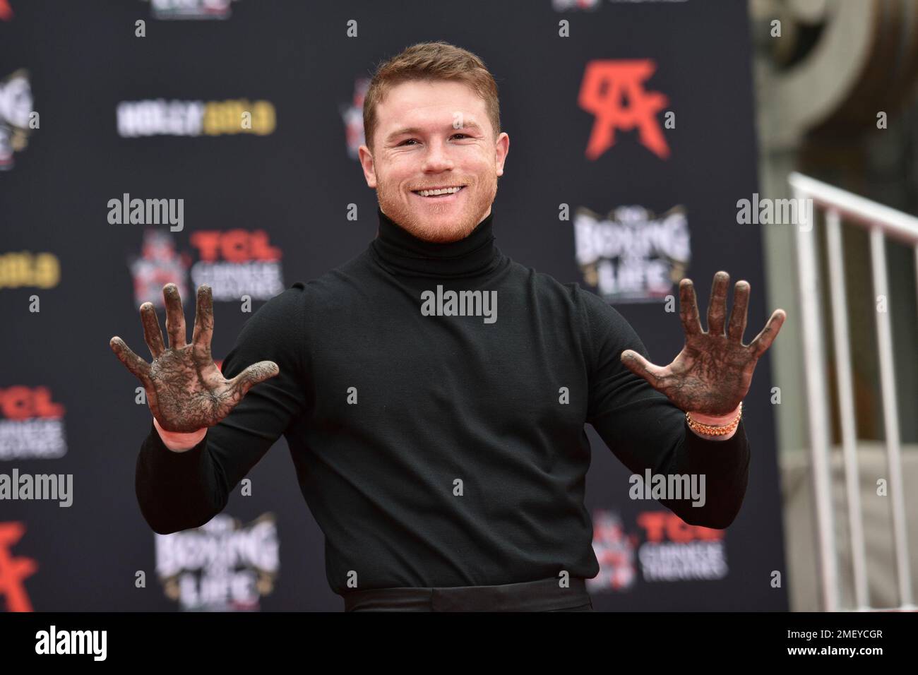 Boxer Canelo Alvarez poses for photos after placing his hands in cement ...