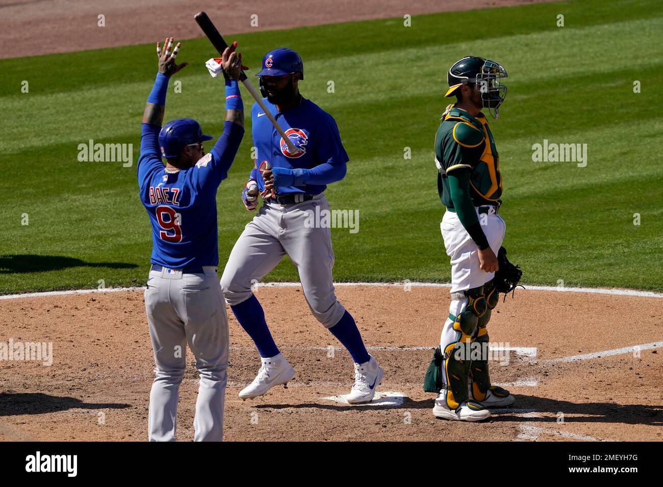 Chicago Cubs' Jason Heyward and Javier Baez (9) score on a double hit ...