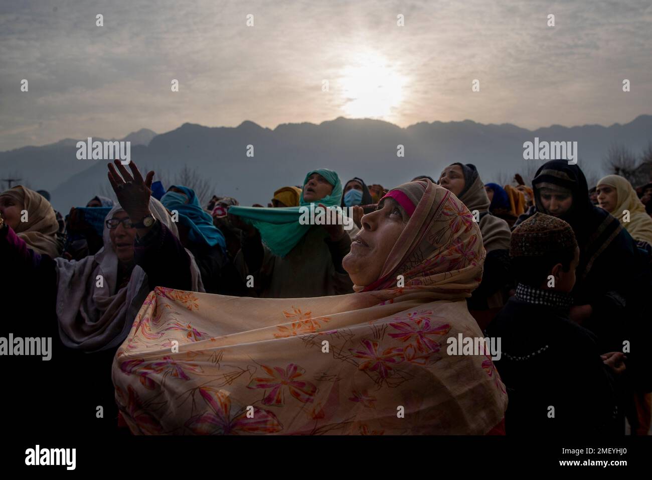 Kashmiri Muslim devotees pray as the head priest displays a relic ...
