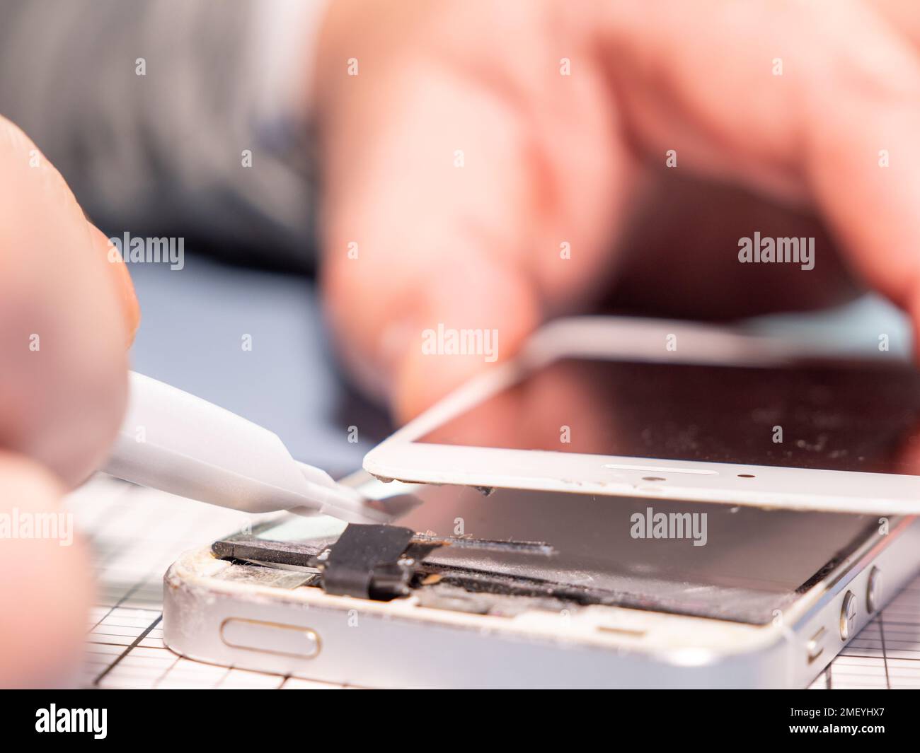 A technician repairs a smartphone in a laboratory with copy space ...
