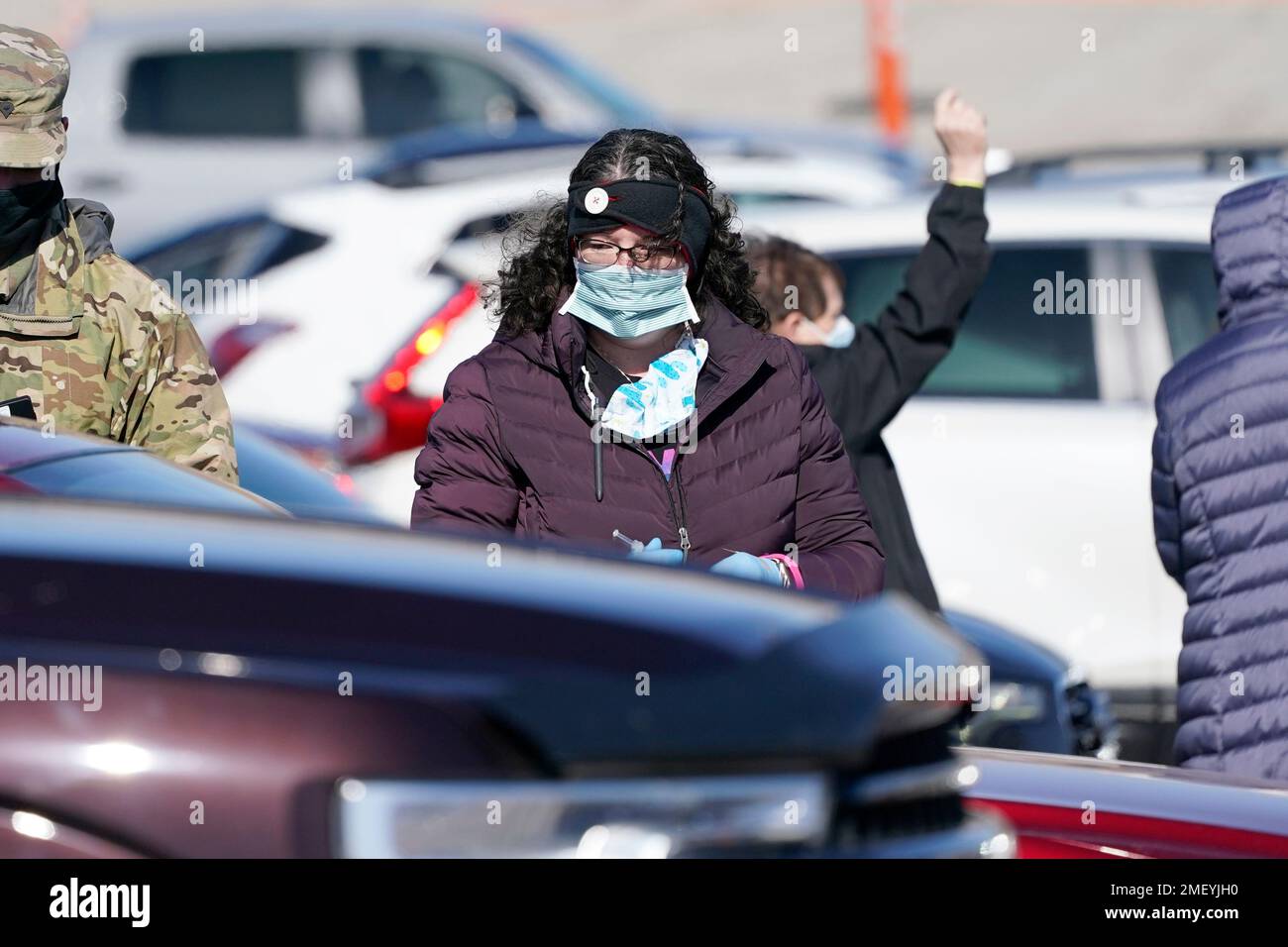 A nurse works at a drive-thru mass COVID-19 vaccination site in Kansas ...