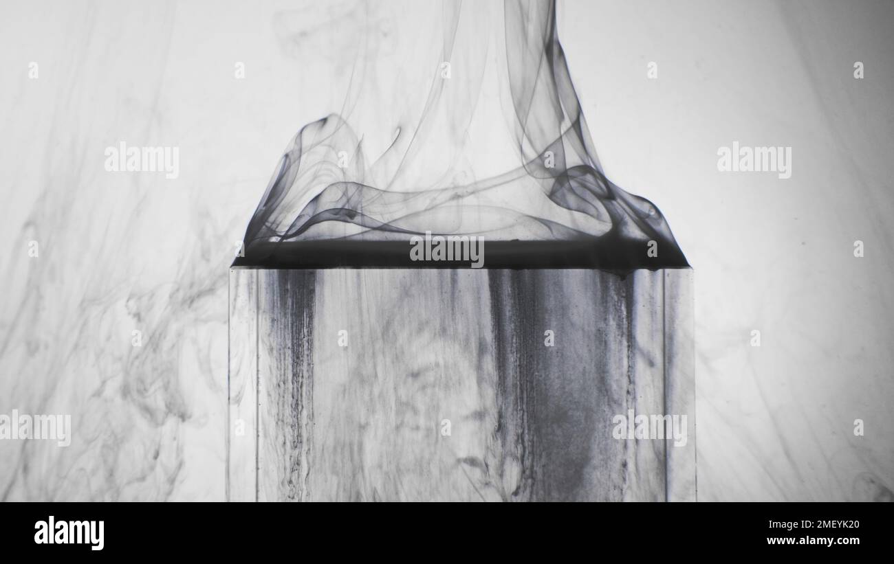 Steam floating ice cube ink water black smog white Stock Photo - Alamy