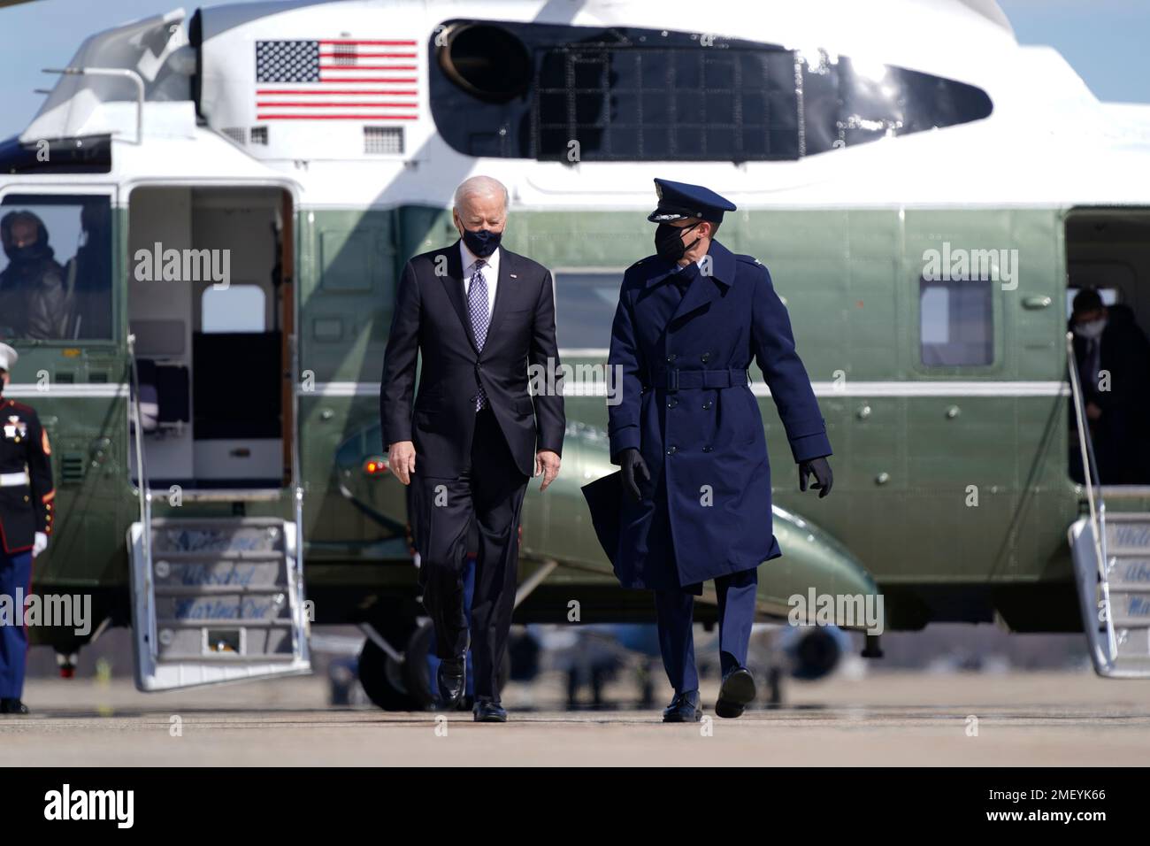President Joe Biden walks with Air Force Col. Stephen Snelson ...