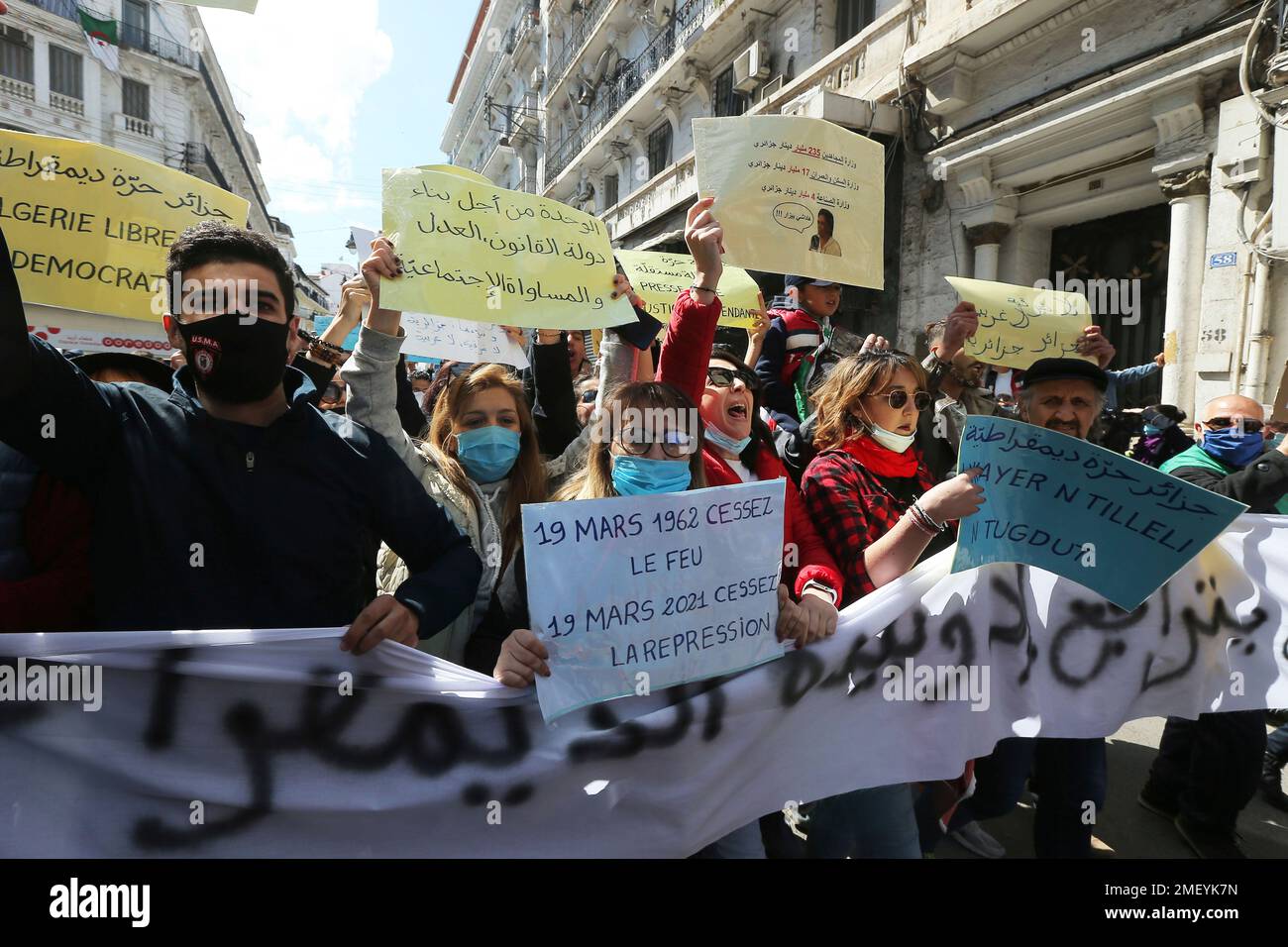 Algerians protesters march with posters during their weekly pro ...