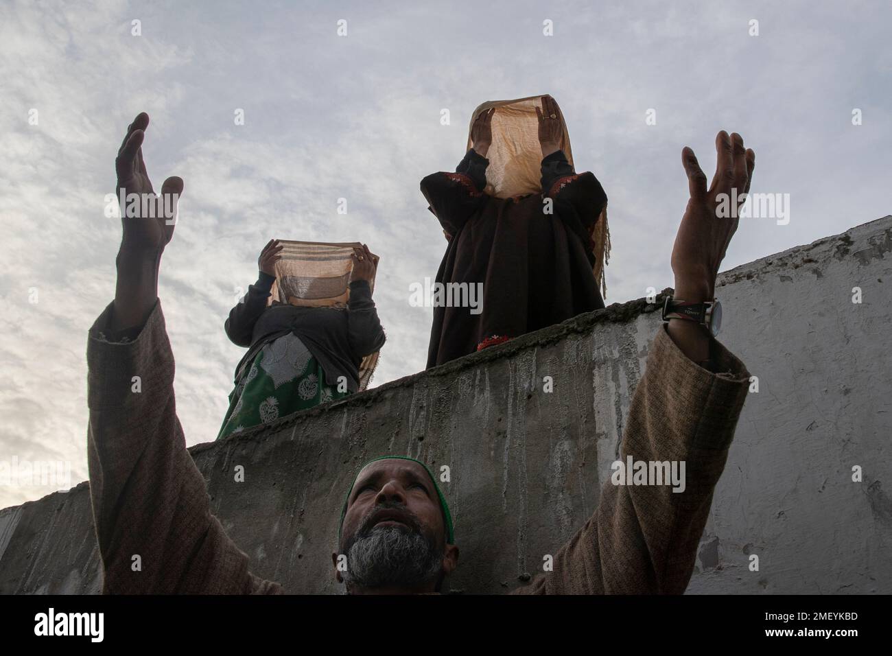 Kashmiri Muslim devotees pray as the head priest displays a relic ...
