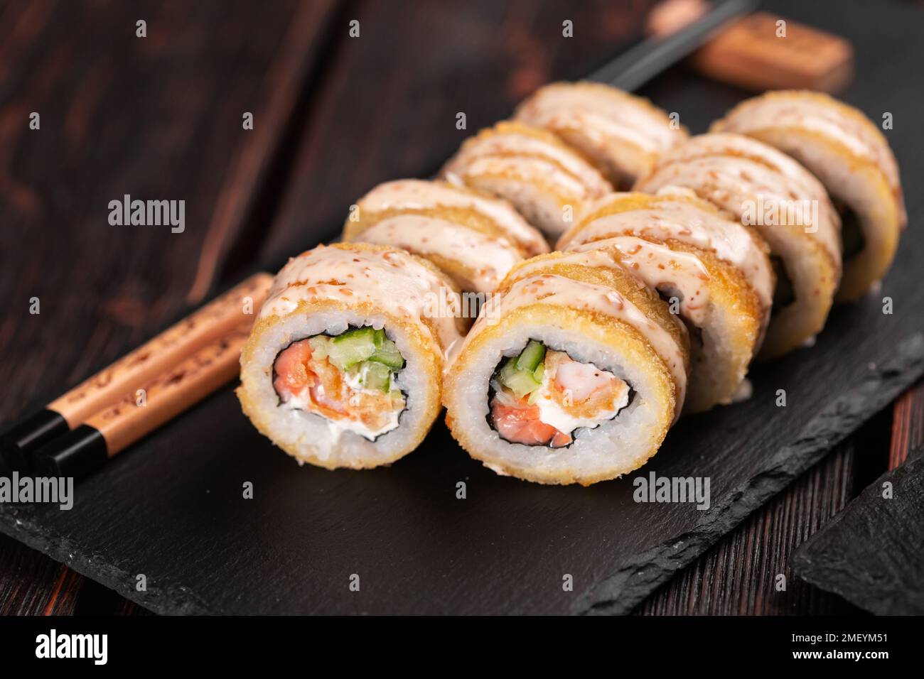 Roll with fish sushi with chopsticks - asian food concept Stock Photo ...
