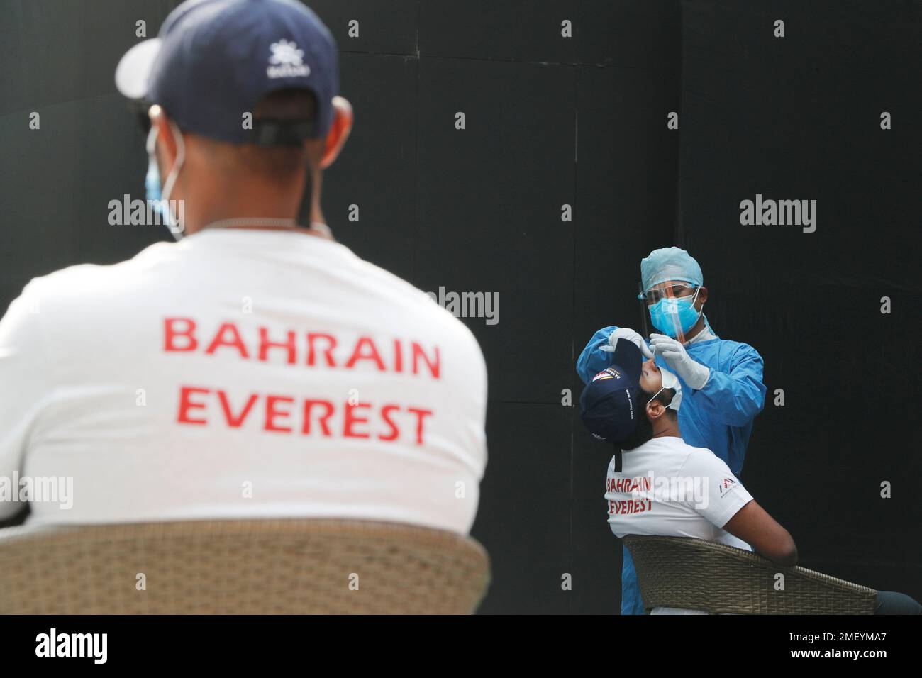 A health worker collects a swab sample from a member of an expedition ...