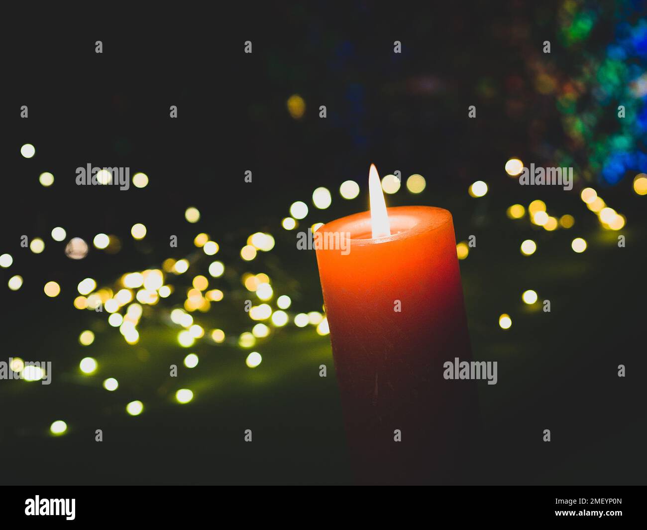 A closeup shot of a burning candle on a glowing bokeh background Stock ...