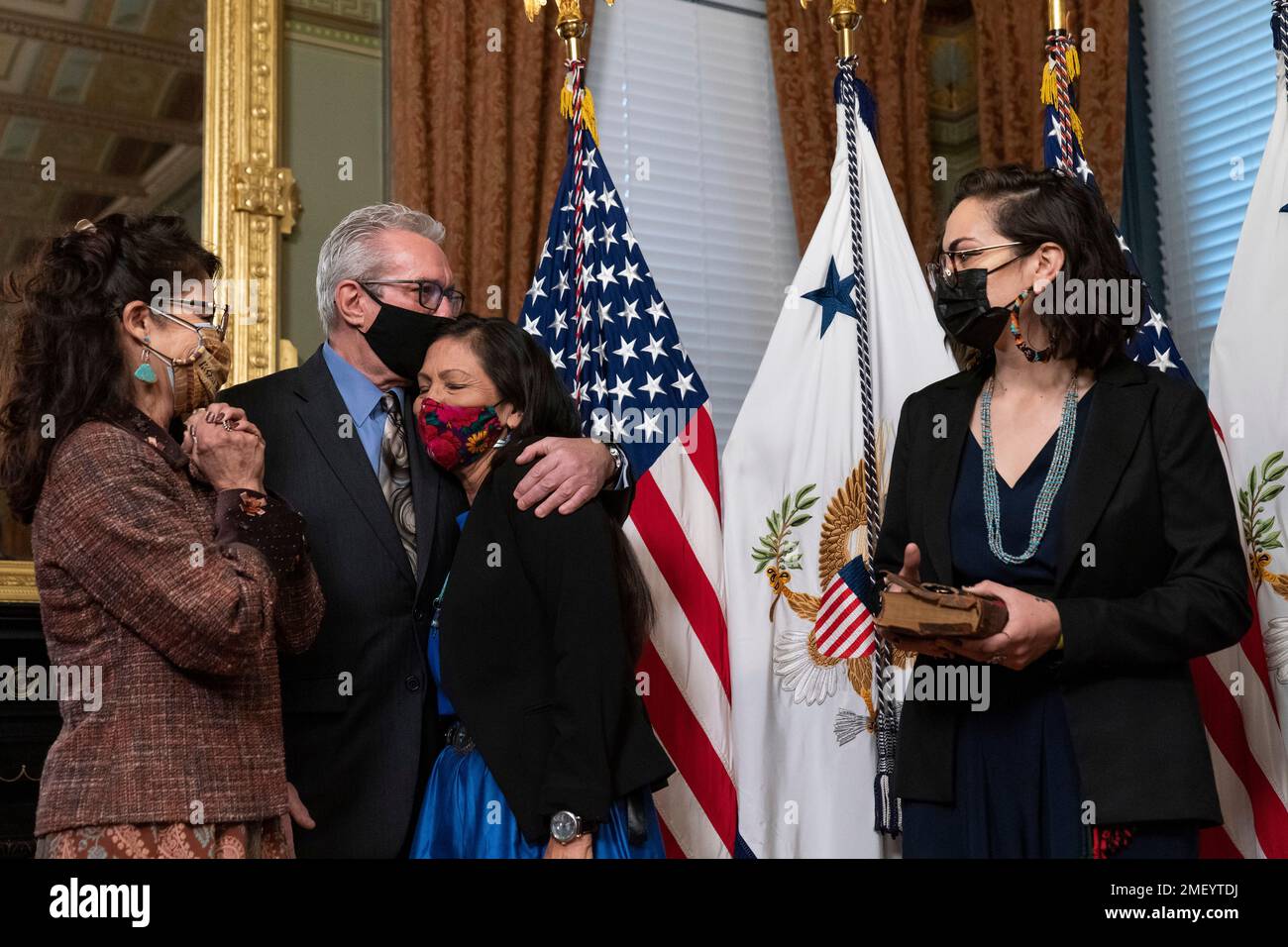 Interior Secretary Deb Haaland, third from left, hugs partner Lloyd ...