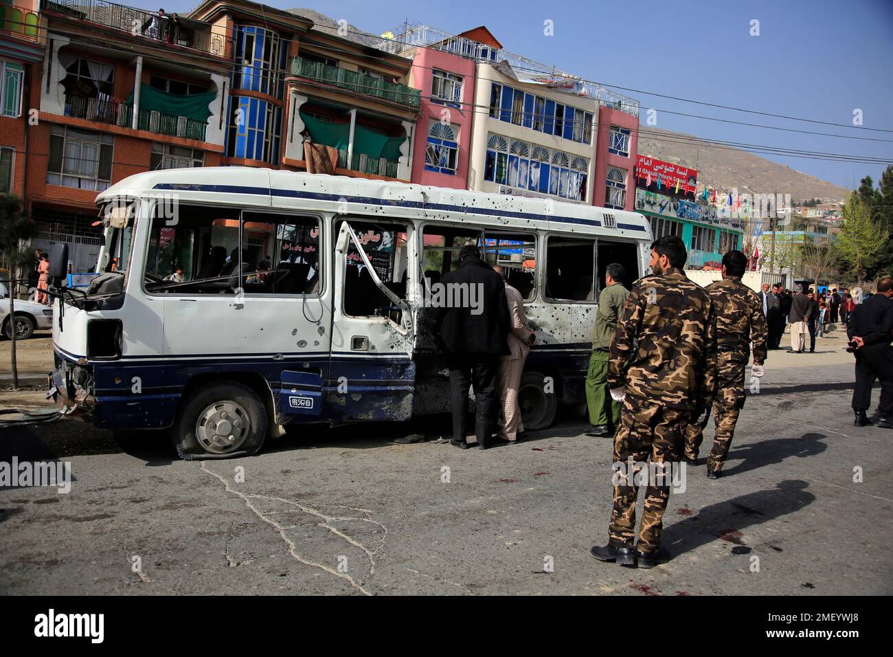 Security personnel inspect a damaged minibus after a bomb explosion in ...